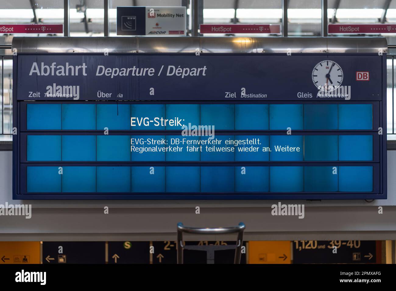 Big departure info board inside of a train station, displaying EVG ...
