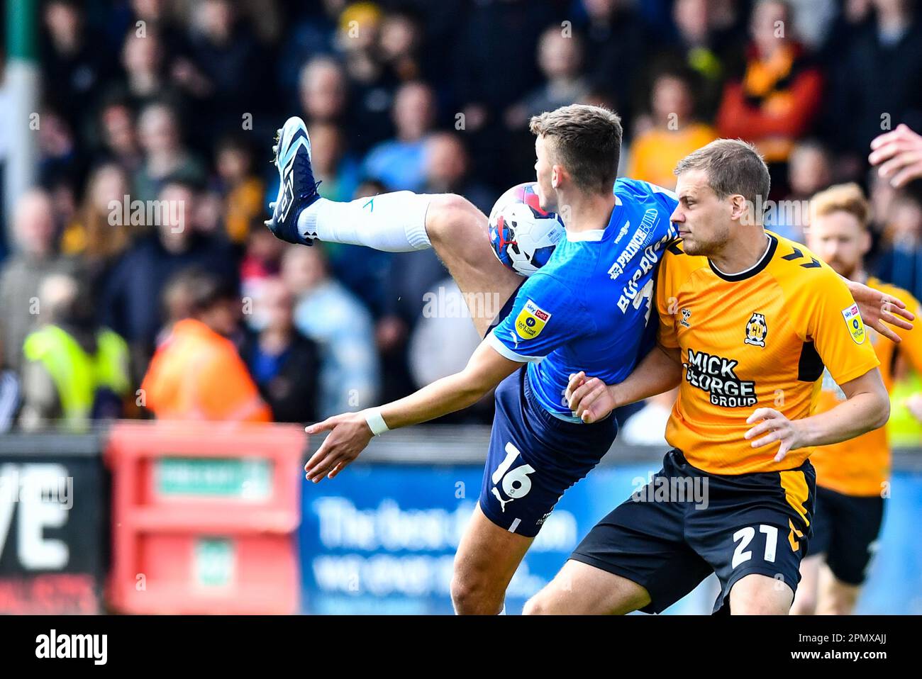 Harrison Burrows (16 Peterborough United) challenged by Ryan Bennett ...