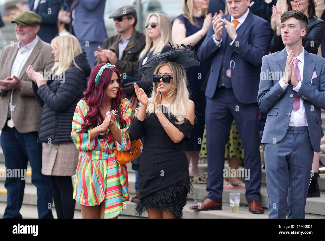 Race goers take part in a minutes applause in memory of the ...