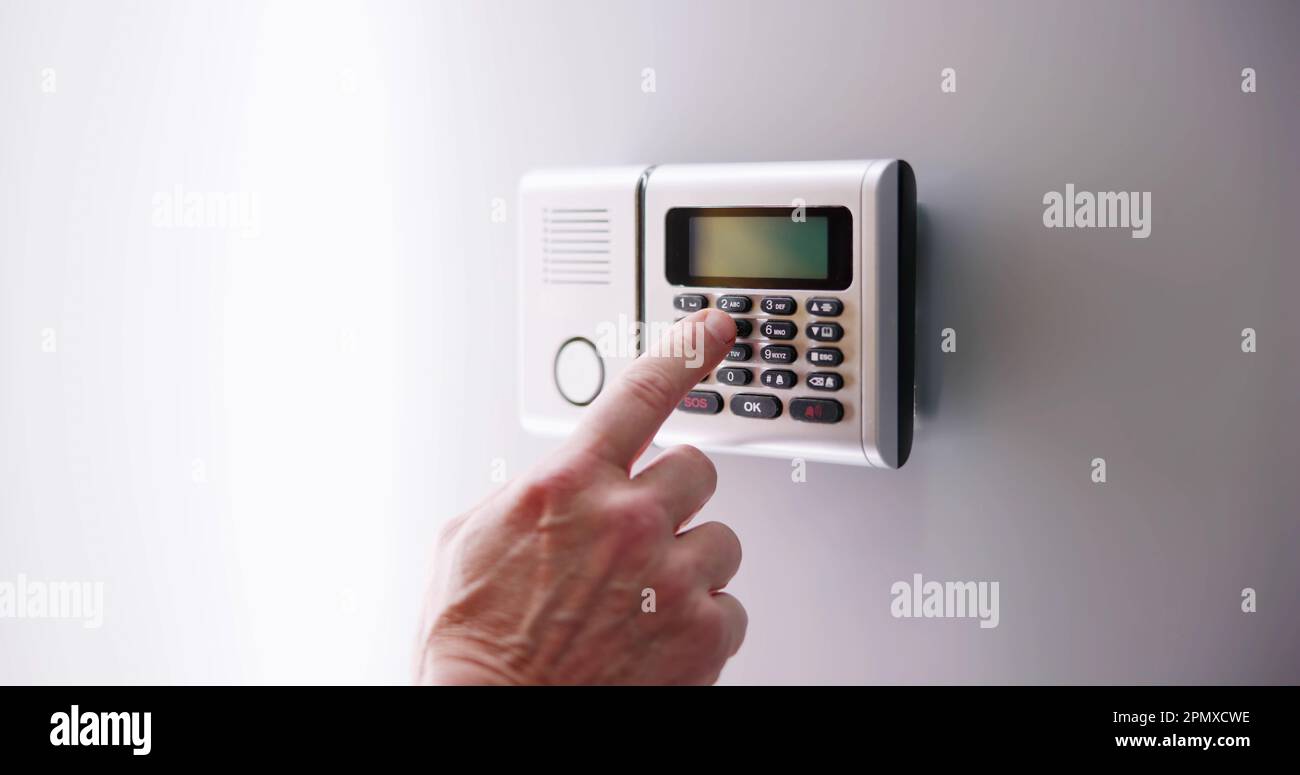 Security Alarm Keypad With Person Arming The System Stock Photo - Alamy