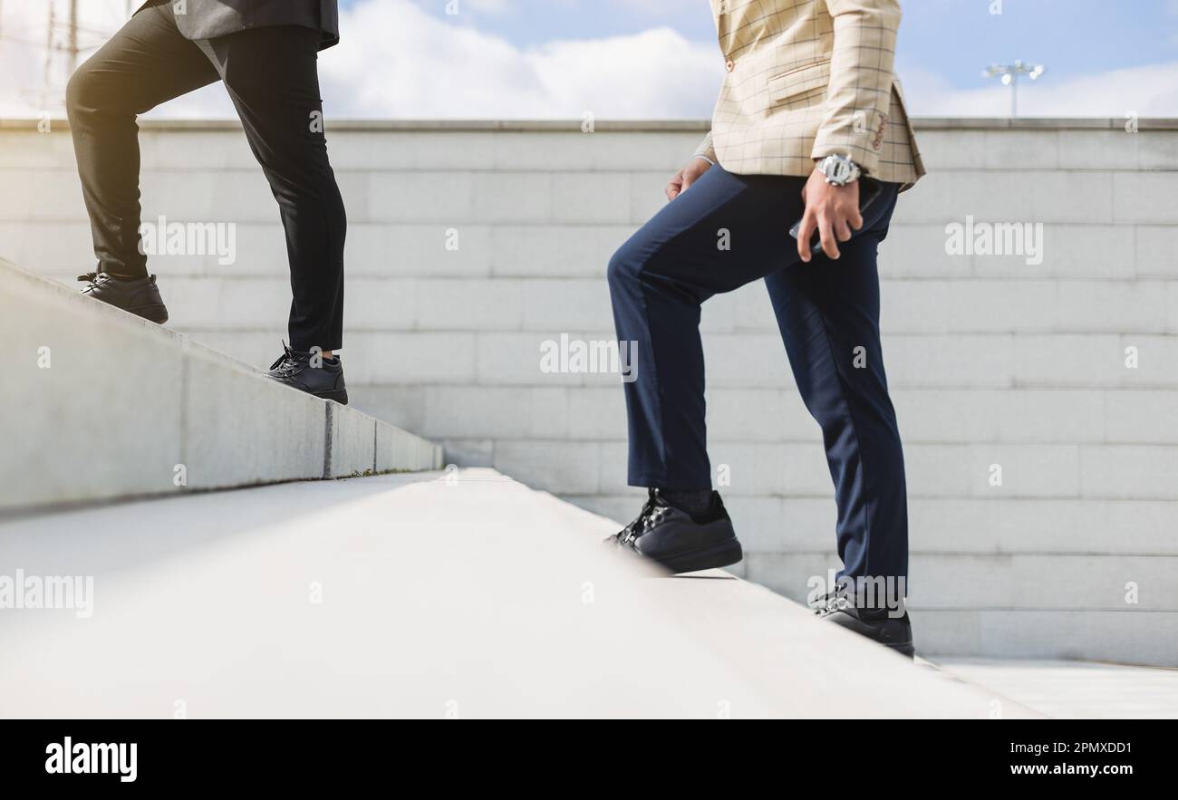 Business people climb the steps of the city stairs. impersonal rising ...
