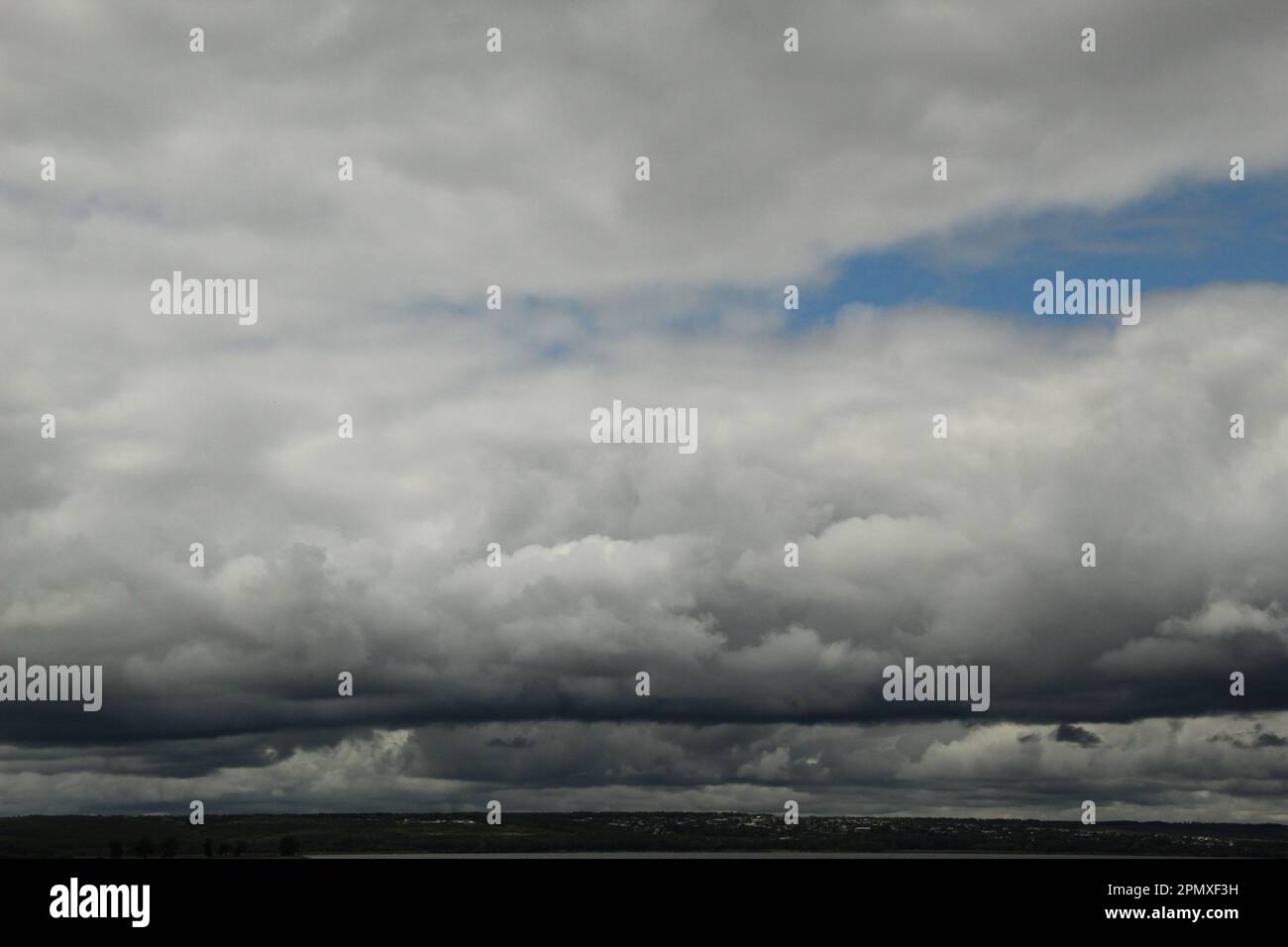 Heavy gray storm clouds hanging over the earth Stock Photo - Alamy