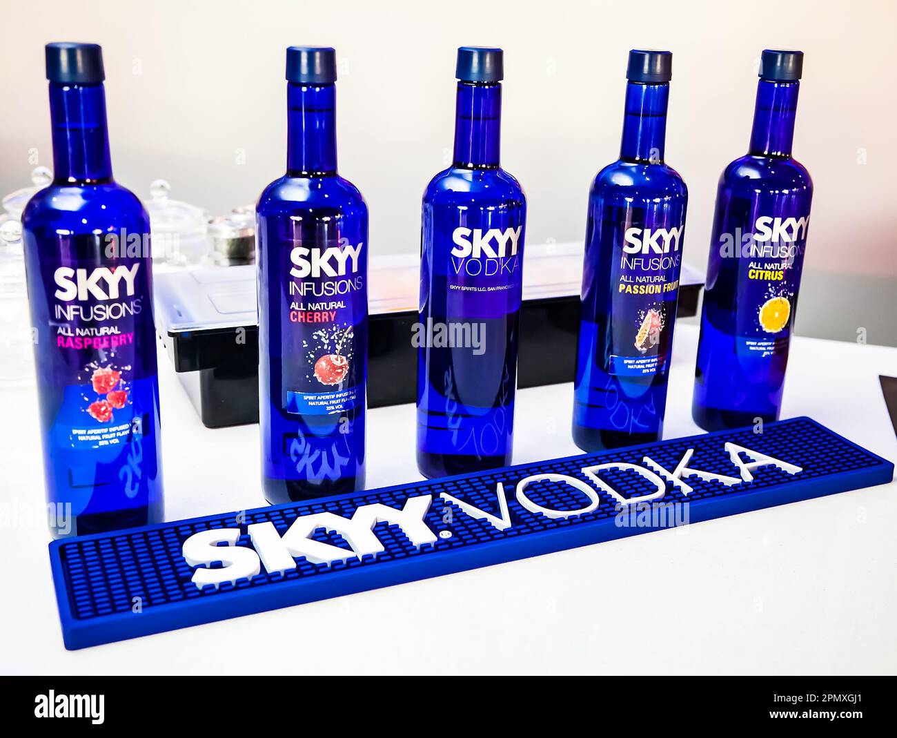An assortment of Skyy Vodka bottles displayed on a white surface Stock ...