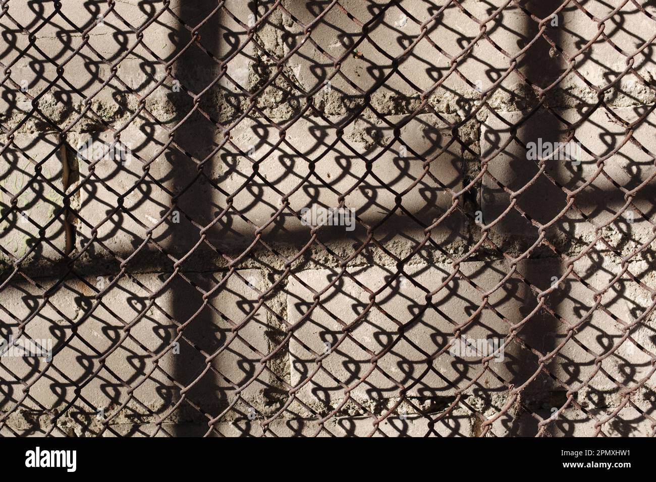 Rusty steel wire mesh on a brick wall. Background texture Stock Photo ...
