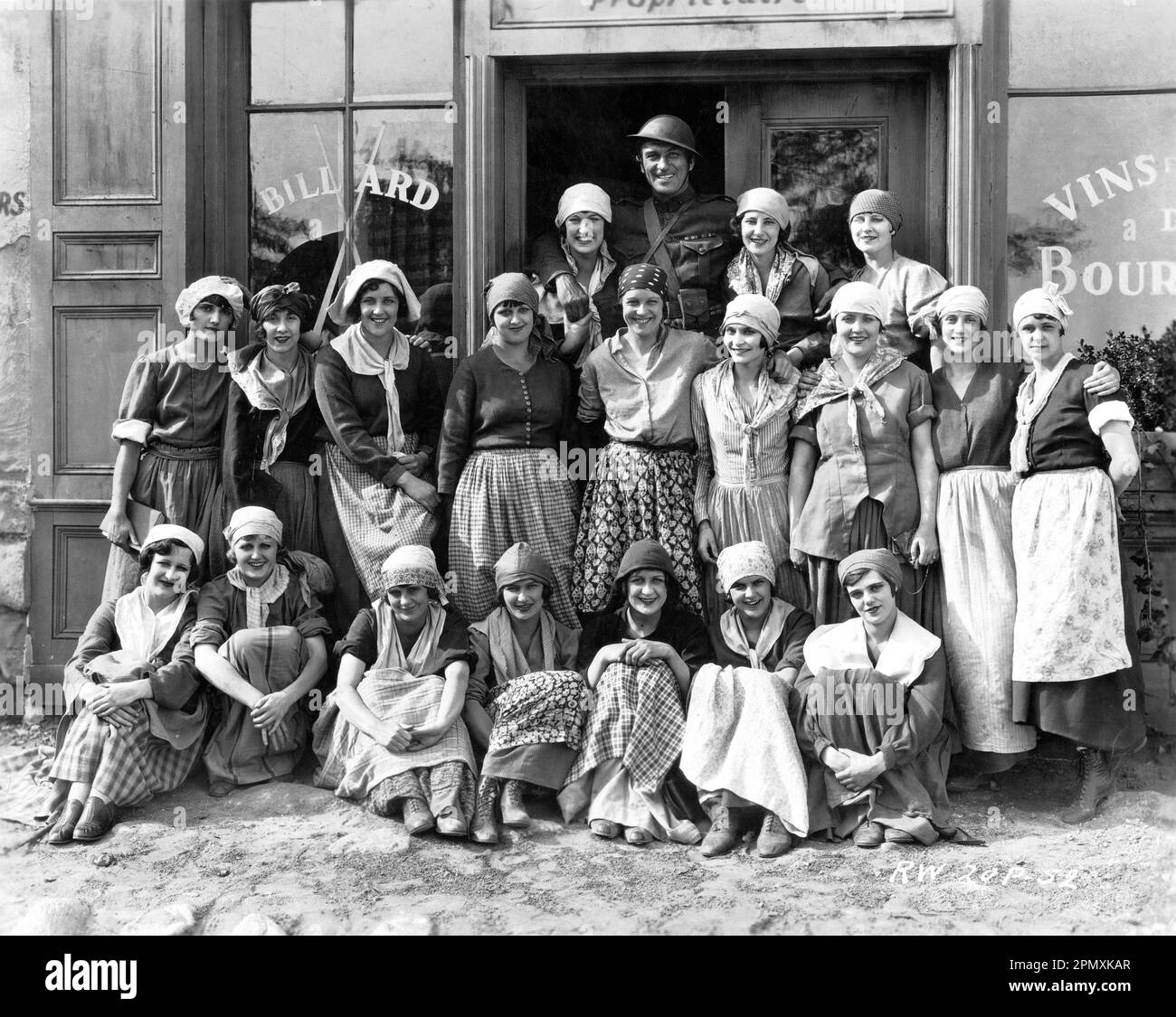 VICTOR McLAGLEN in costume as Captain Flagg poses with Female Extras ...