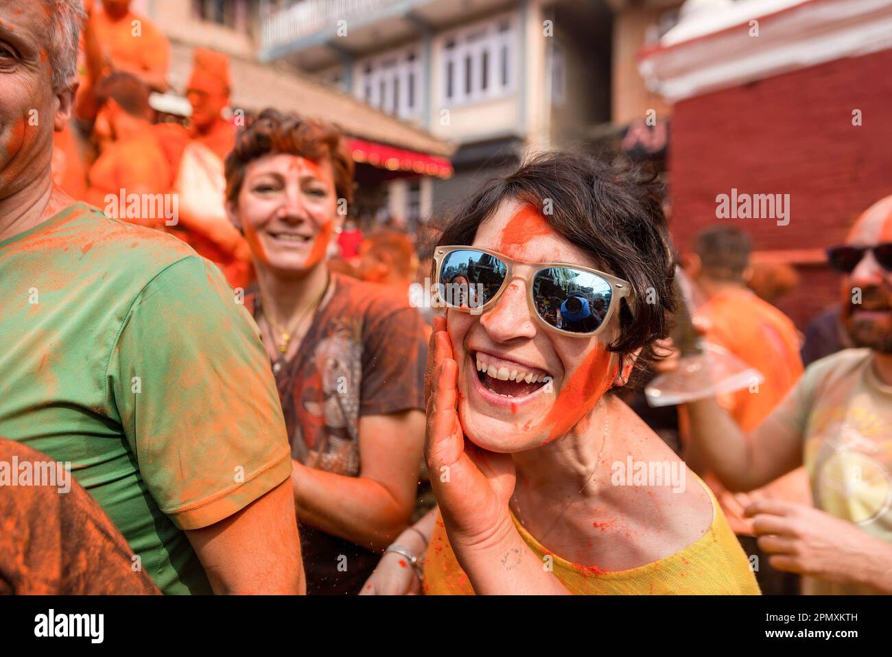 Kathmandu, Nepal. 15th Apr, 2023. A reveler reacts as her face is ...
