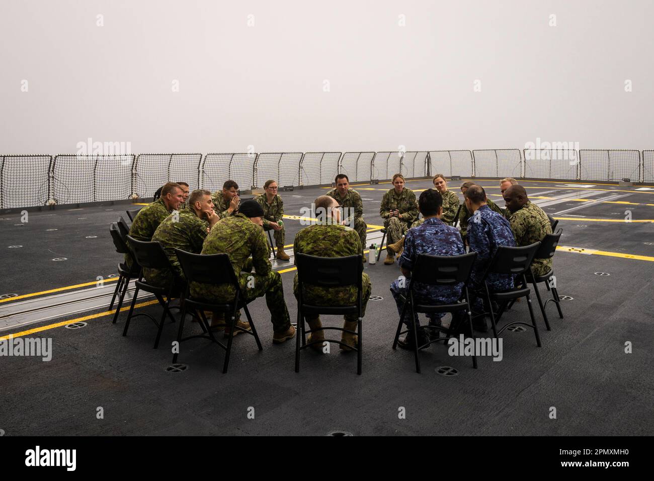 Multi-national military medical personnel gathered in a circle for a ...