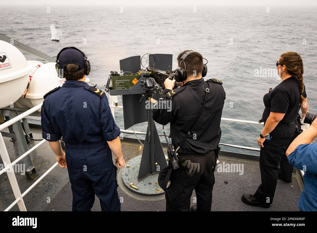 Crew members onboard HMCS Margaret Brooke training at firing a 0.50 ...