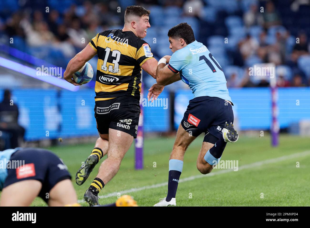 Sam Spink of the Force prepares pass the ball whilst pushing away Ben ...