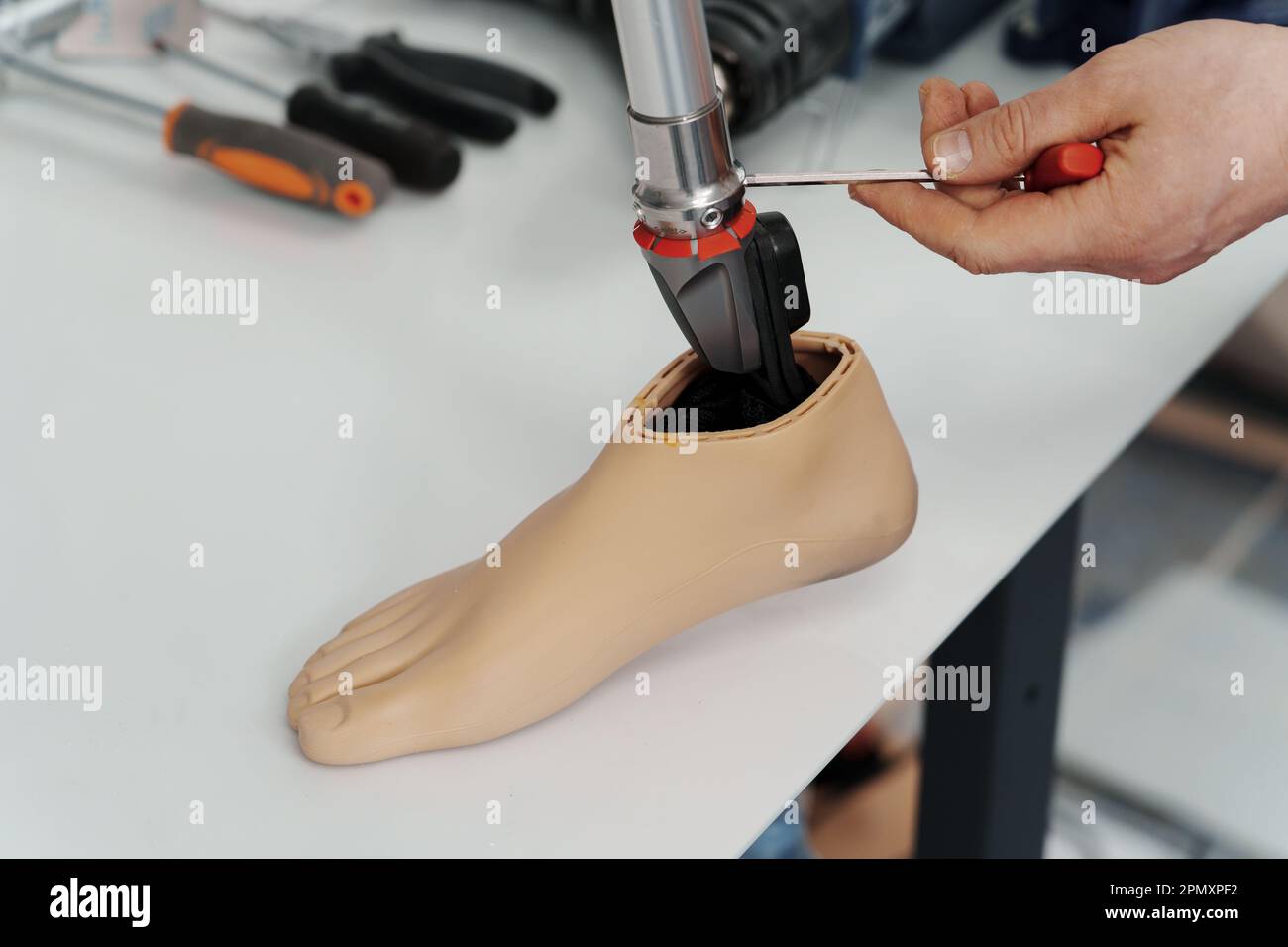 Master screwing and tightening metal part of modern prosthetic leg ...
