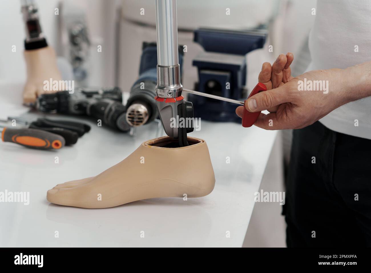 Master screwing and tightening metal part of modern prosthetic leg ...