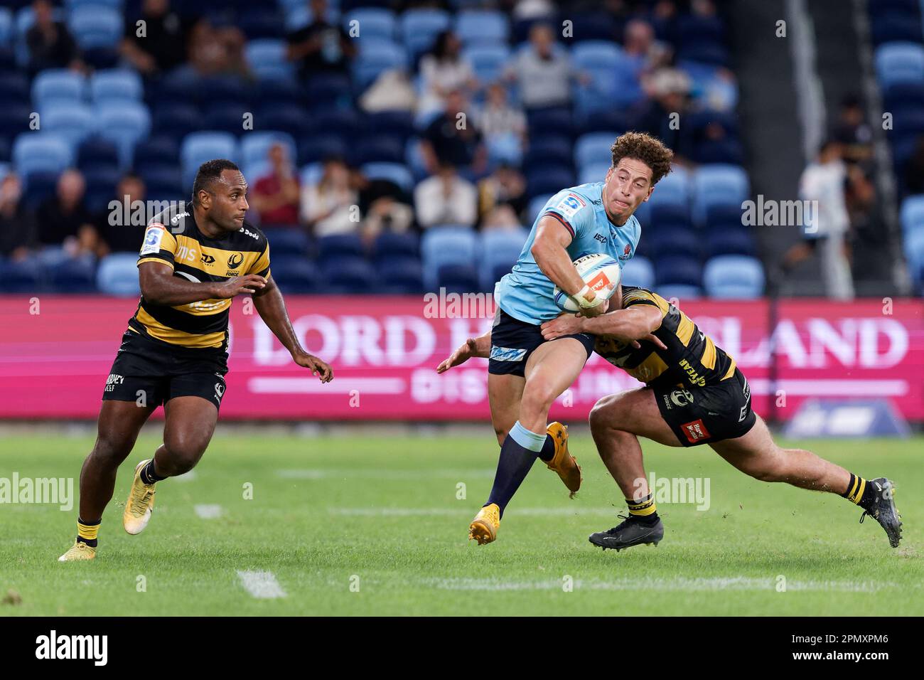 Mark Nawaqanitawase of the Waratahs is tackled during the Super Rugby ...