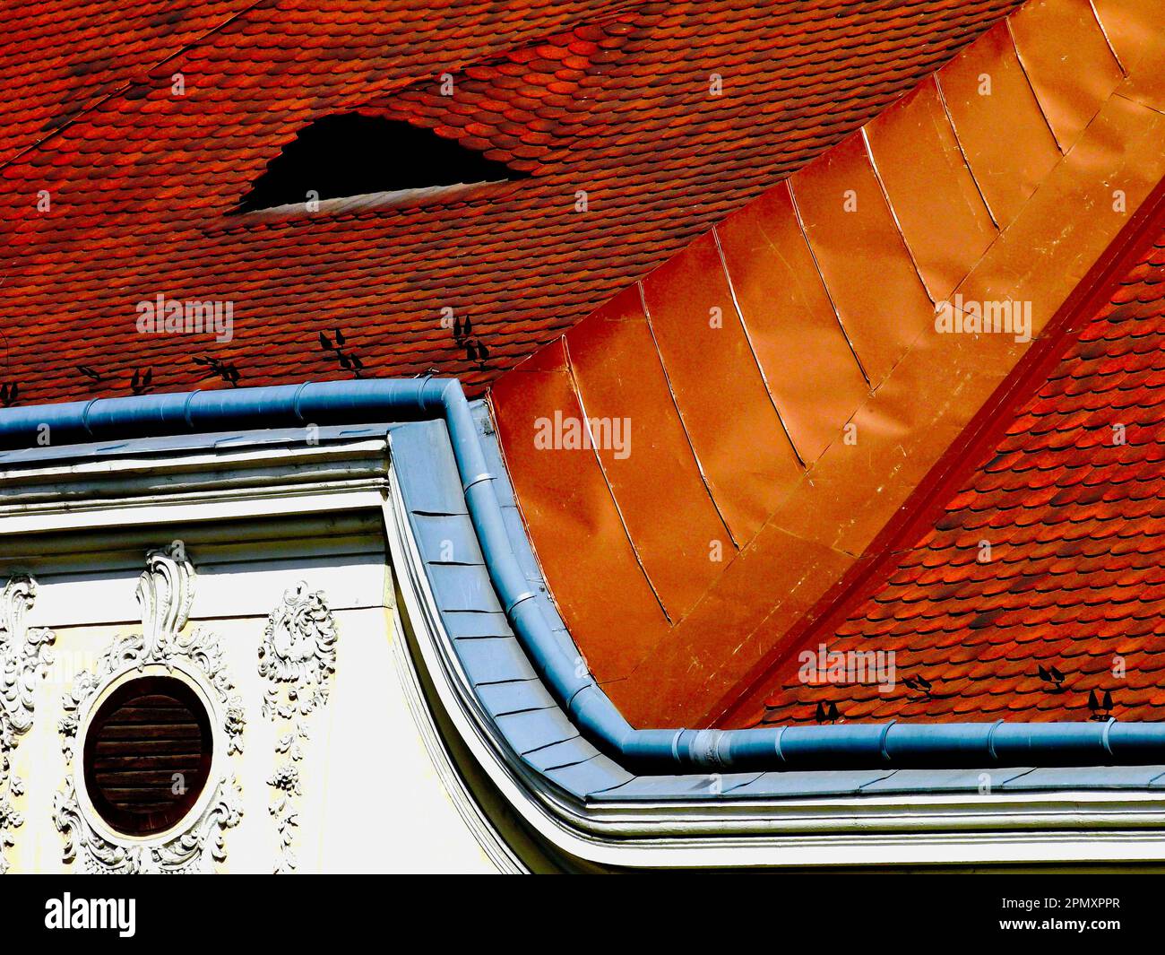 Copper flashing detail on sloped brown clay tile roof and dormer. oval ...