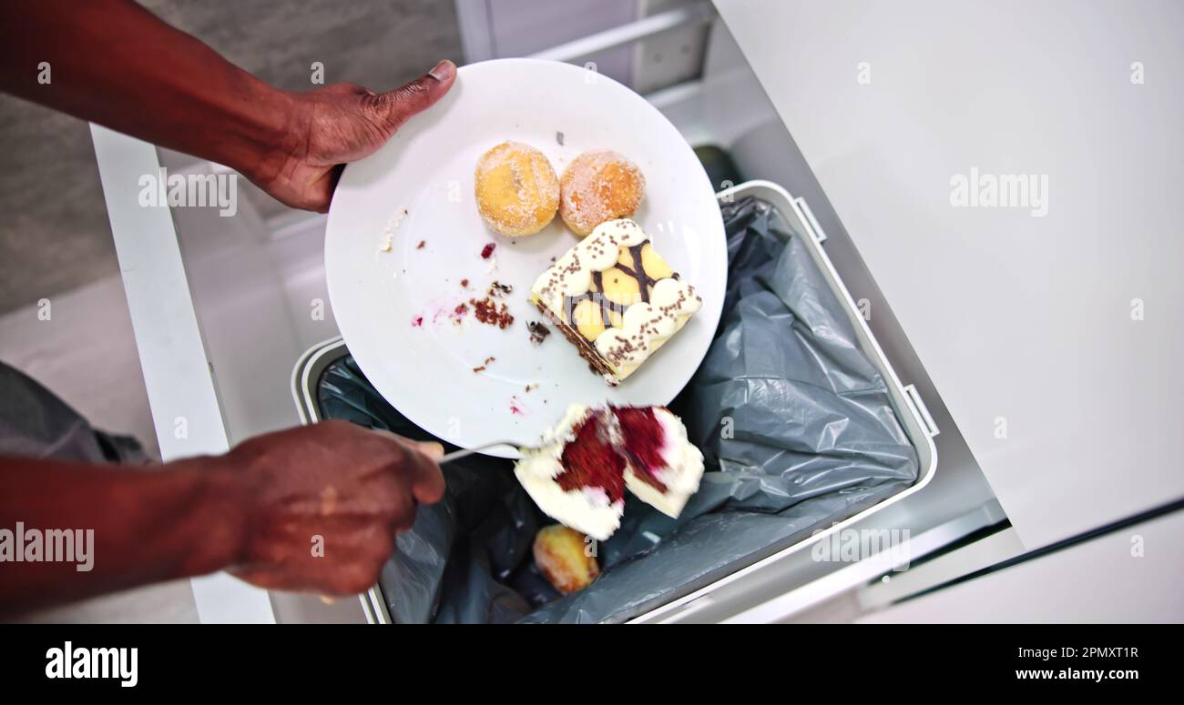 Throwing Away Leftover Food In Trash Or Garbage Dustbin Stock Photo - Alamy