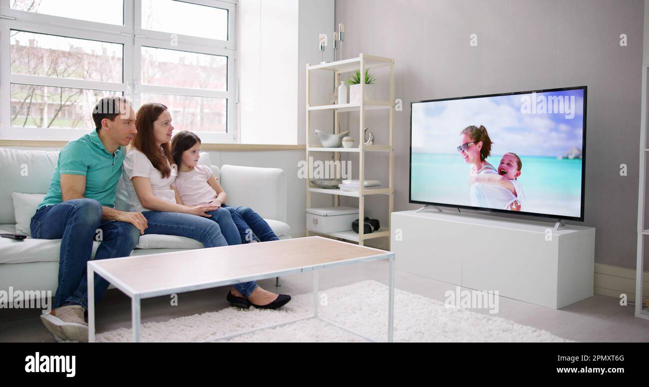 Young Family Watching TV Together At Home Stock Photo - Alamy