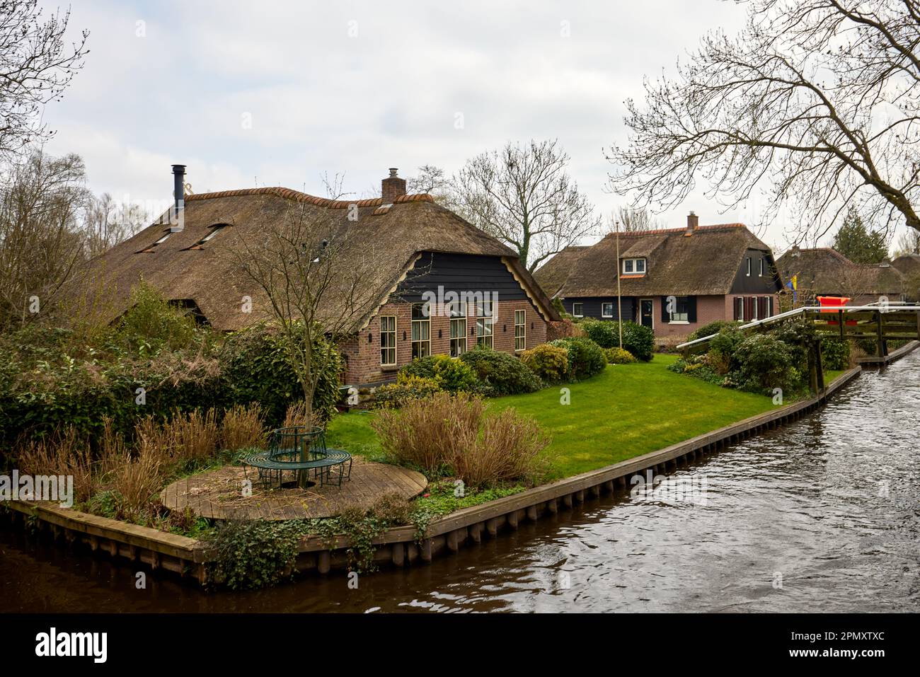 GIETHOORN, NETHERLANDS -typical dutch county side of houses and gardens ...
