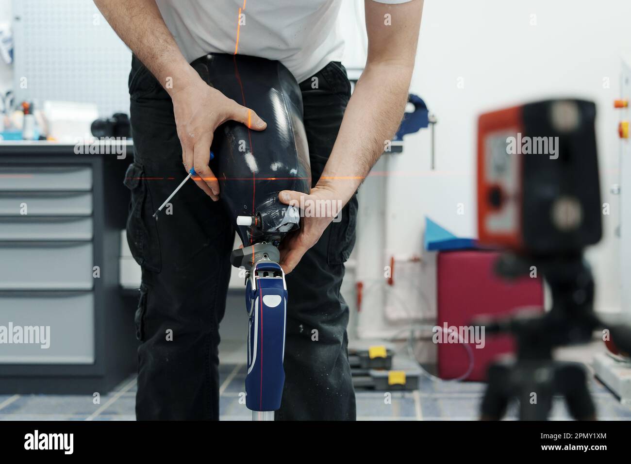 Crop unrecognizable craftsman adjusting and bending modern prosthetic ...