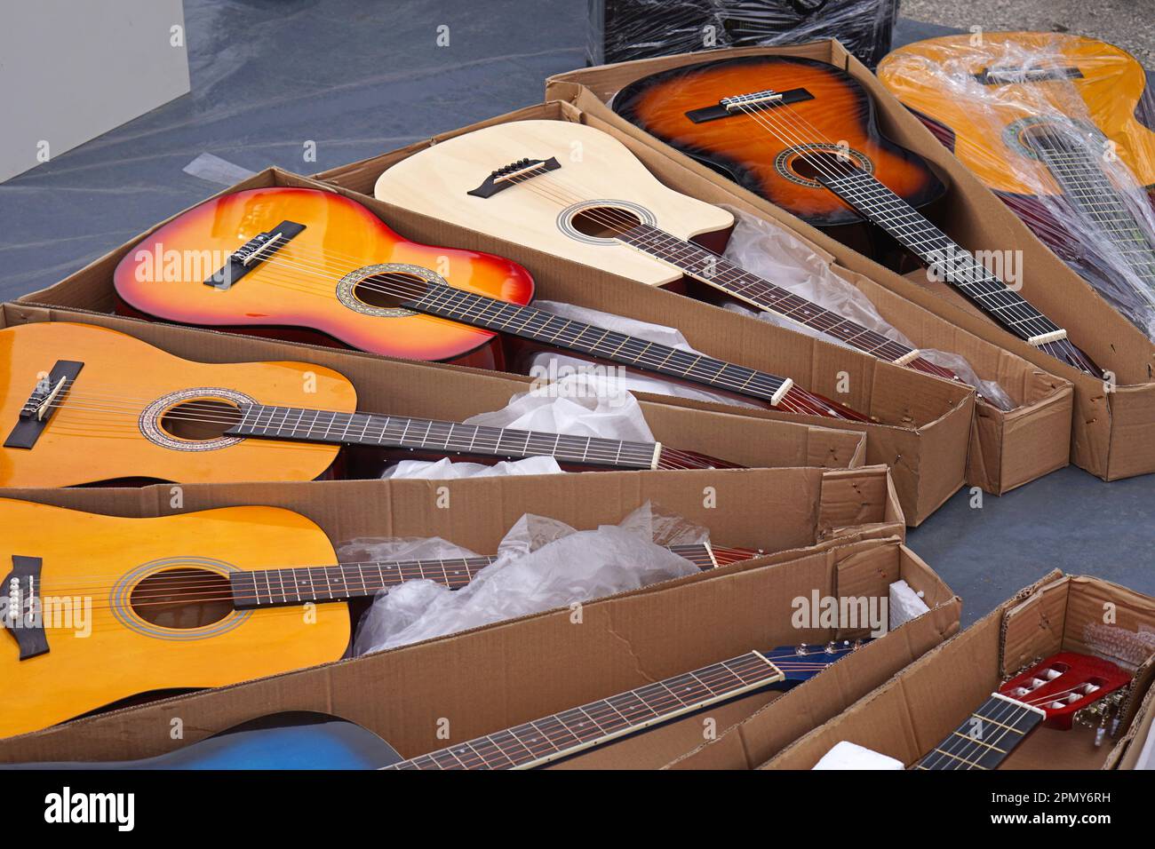 Many new acoustic guitars music instruments in boxes for sale Stock ...