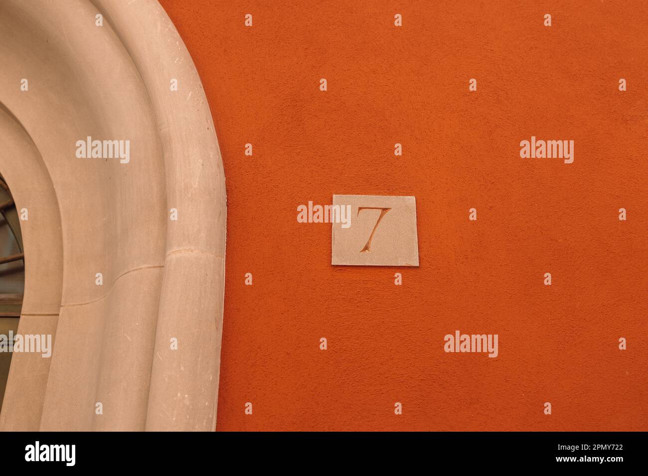 House number 7 over brick sunny orange wall. Houses with personality ...