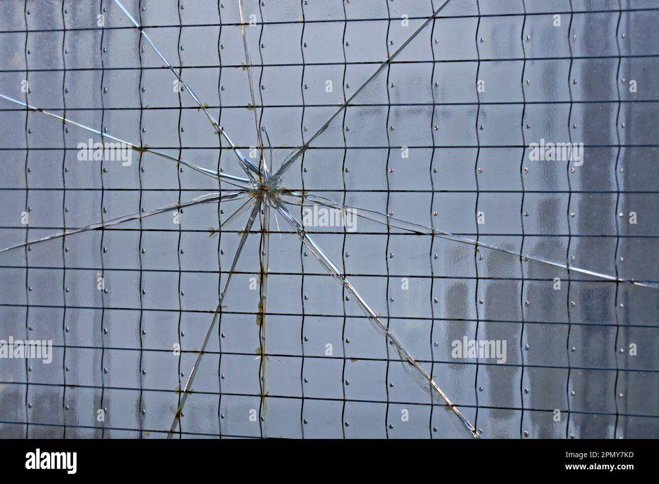 Cracked safety tempered glass window damage problem Stock Photo - Alamy