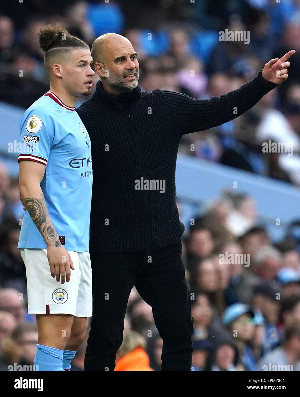 Manchester City manager Pep Guardiola (right) speaks to Kalvin Phillips ...
