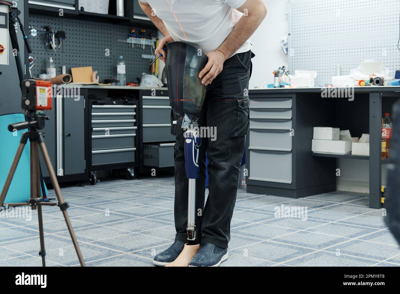 Crop unrecognizable craftsman adjusting and bending modern prosthetic ...