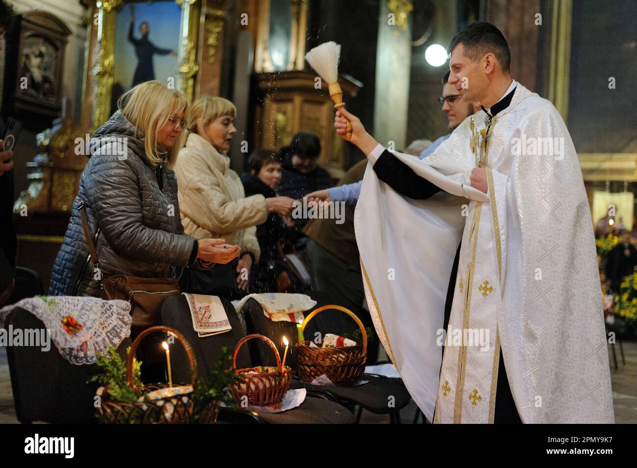 Lviv, Ukraine 15 April 2023. A Ukrainian priest blesses believers at a ...