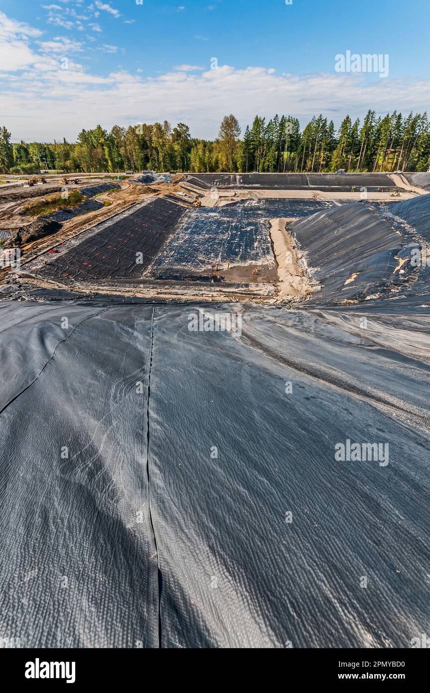 Geomembranes on hills and excavations in the distance below in an ...