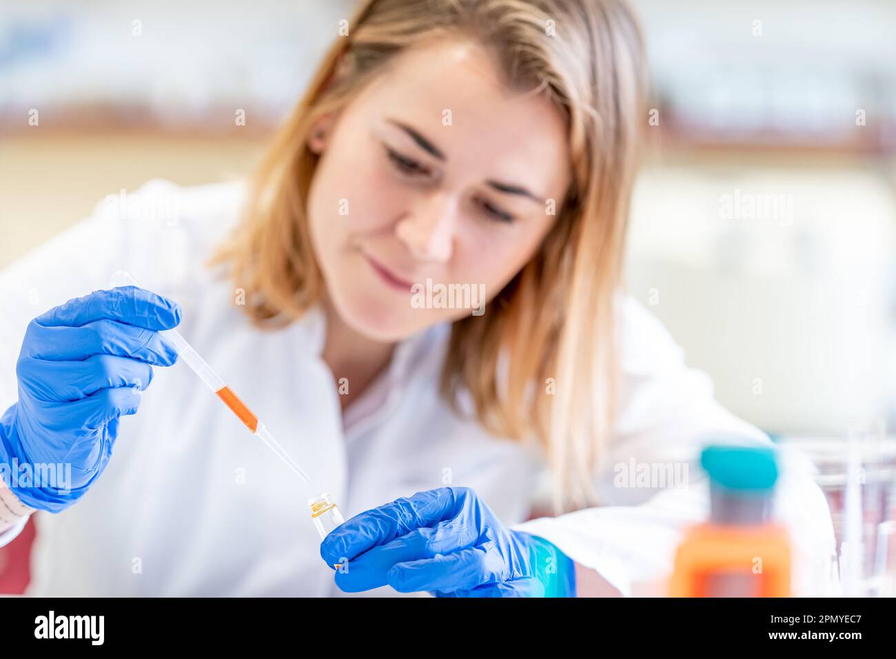 female scientist conducts chemical experiments in a research laboratory ...
