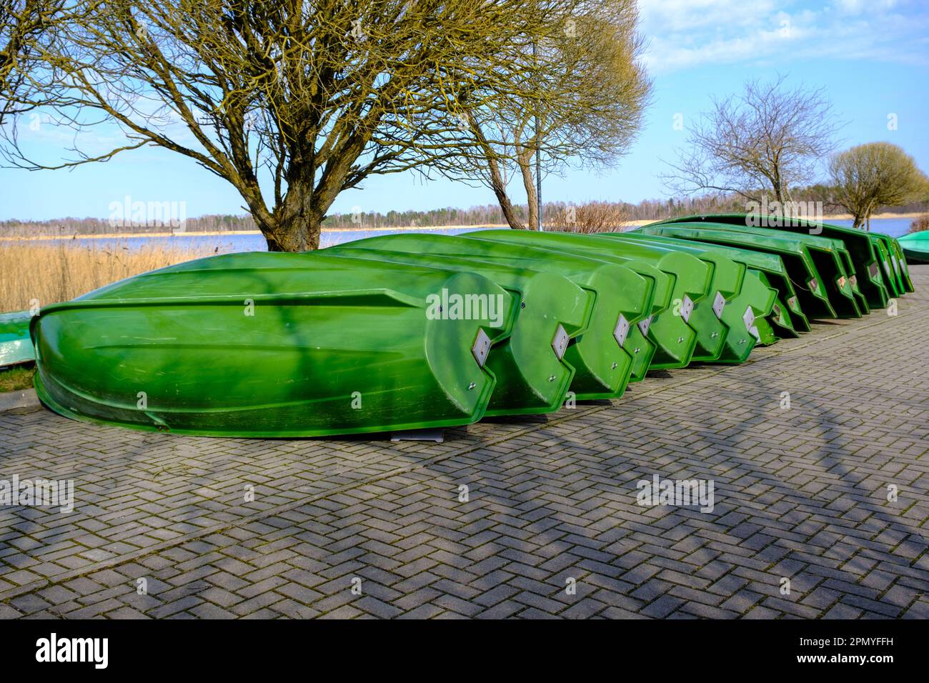 a lot of plastic boats in green color on the shore Stock Photo - Alamy
