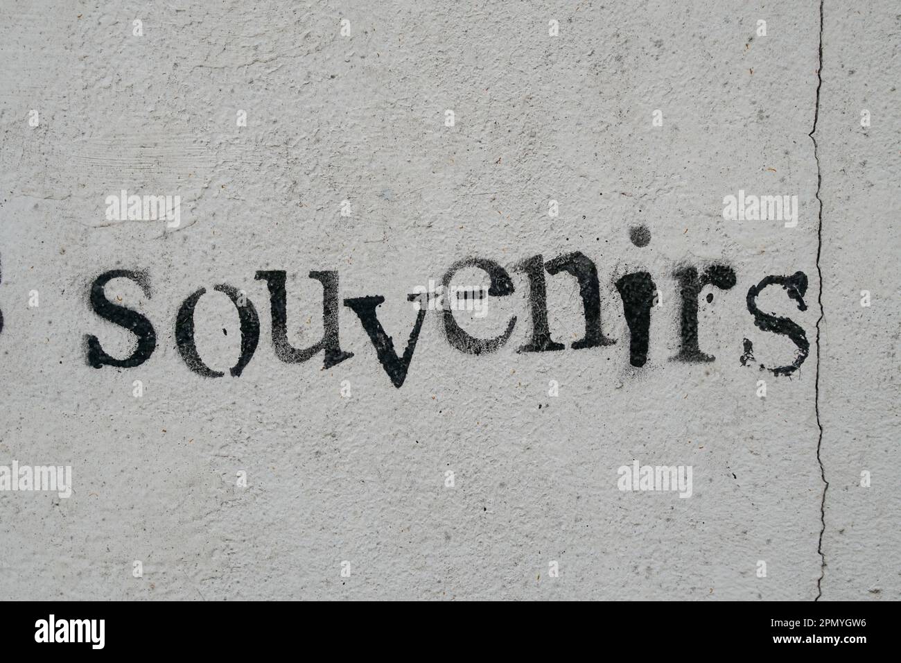 the writing souvenirs painted with stencil on the wall Stock Photo - Alamy