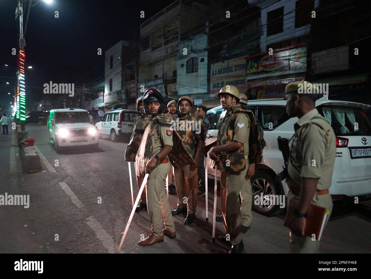 Policemen stand guard the area where gangster-turned-politician Atiq ...