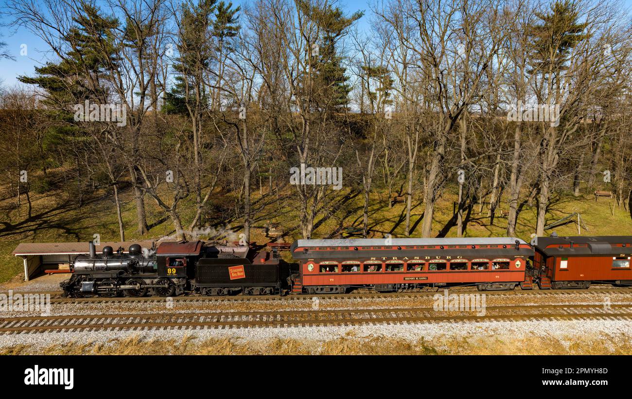 An aerial view of a steam train on tracks through a rural countryside ...