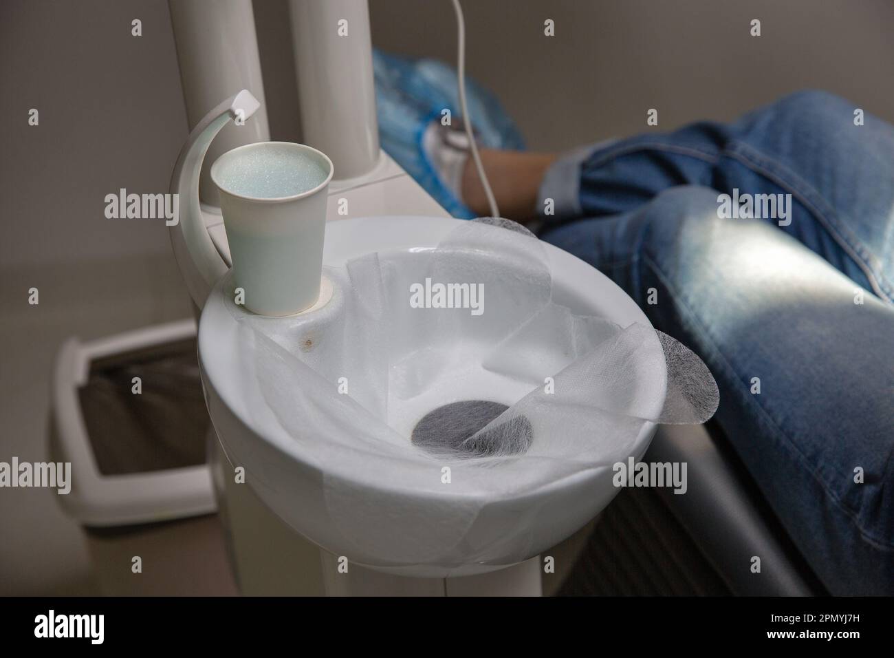 sink for rinsing the mouth area after dental procedures and cup with ...