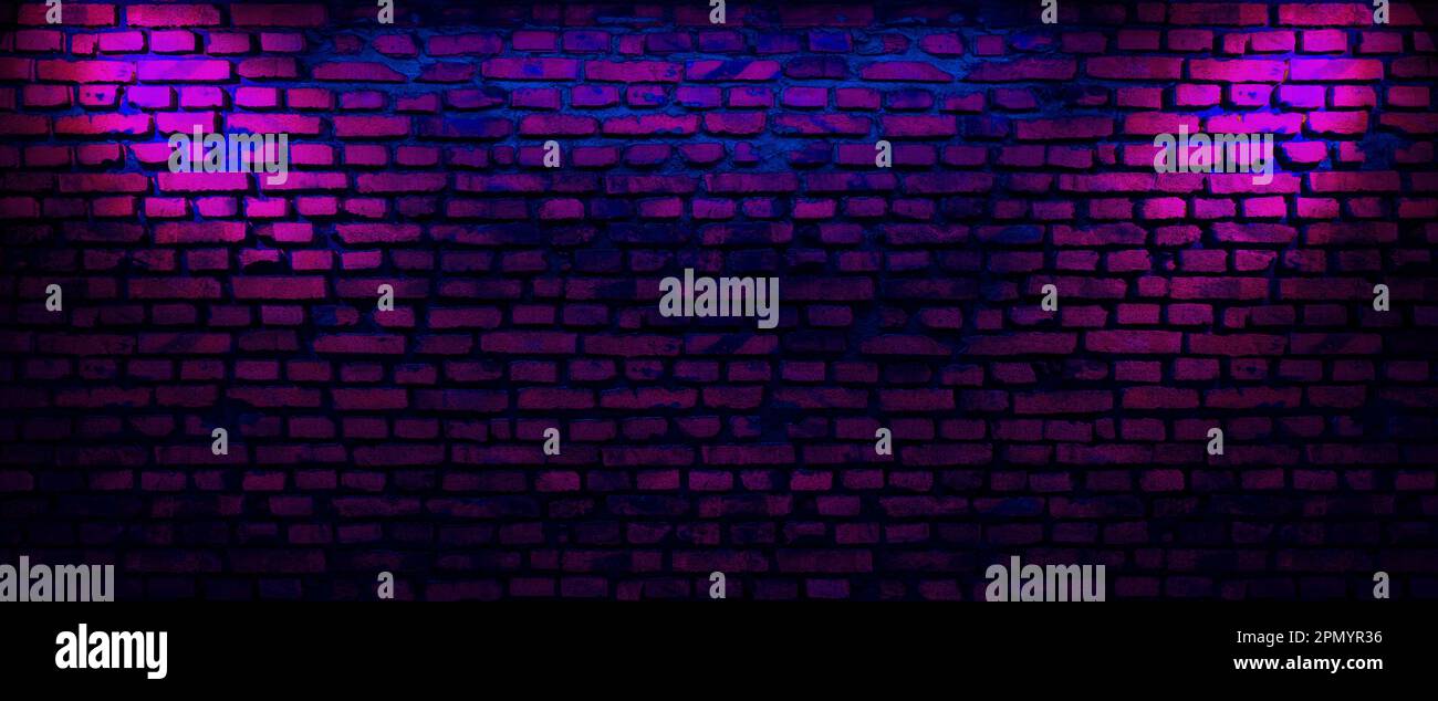 Dark brick wall background with neon lighting effect pink purple and ...