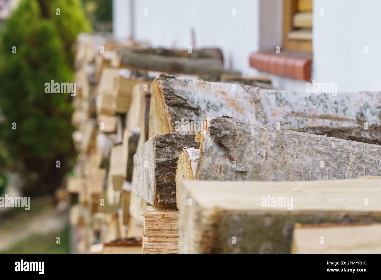 chopped wood stored by a suburban house Stock Photo - Alamy