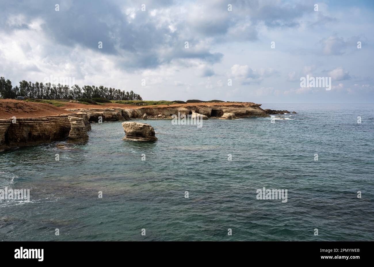 The brown rocks and sea caves at the coast of Peyia, Cyprus Stock Photo ...