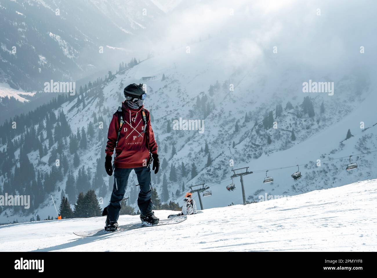Tourist standing on peak of snow covered mountain during vacation Stock ...