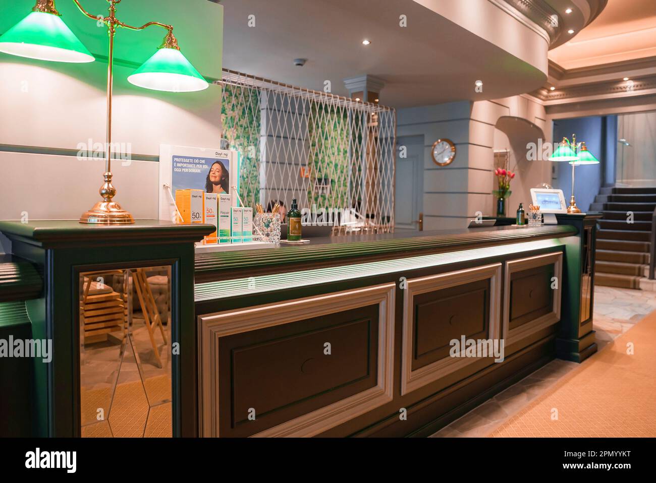 Lighting equipment and cosmetics on reception desk in luxury hotel ...