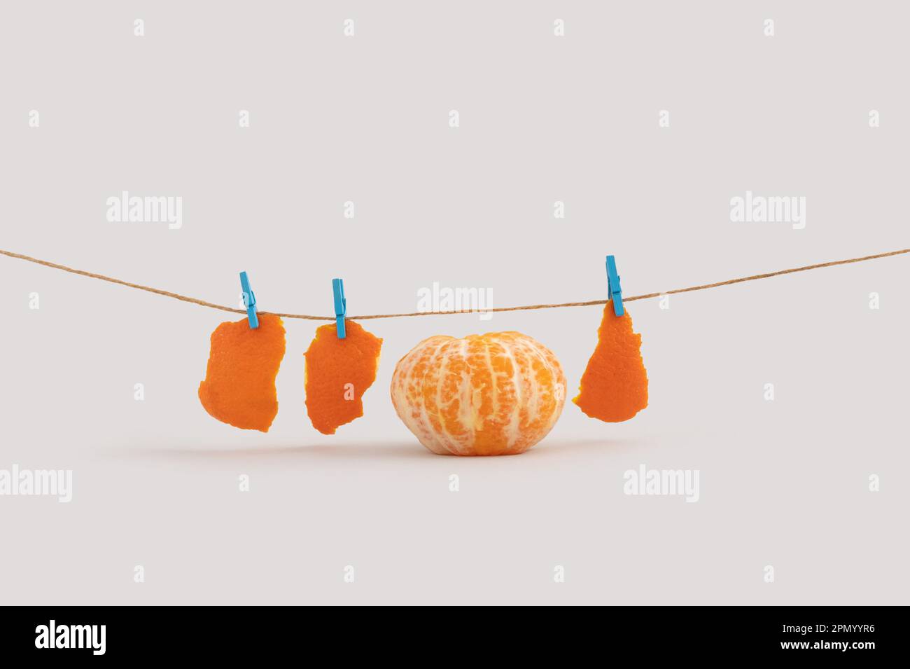 A creative summer concept with peeled tangerine isolated on a white ...