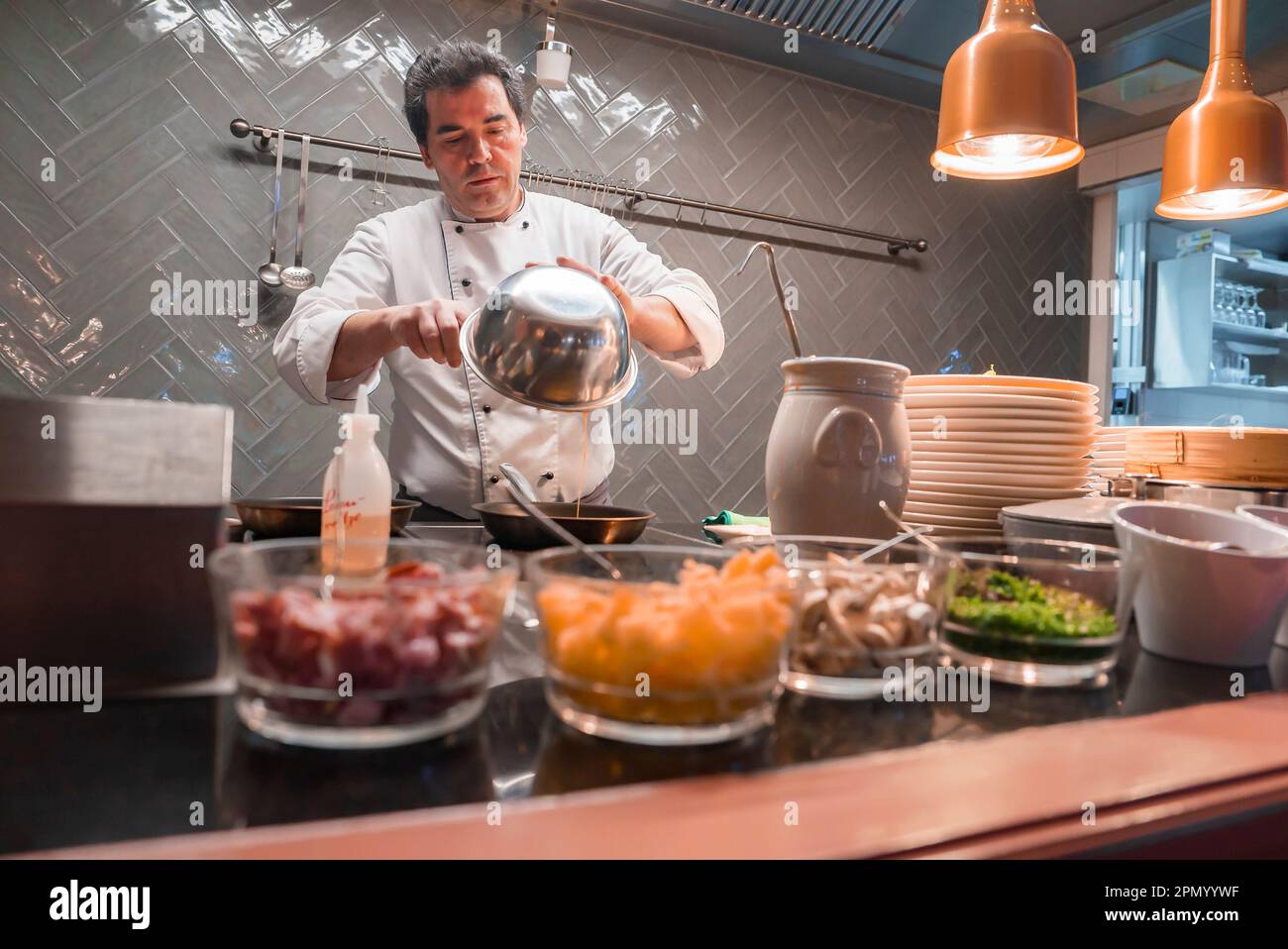 Chef cooking food in commercial kitchen at luxury hotel Stock Photo - Alamy