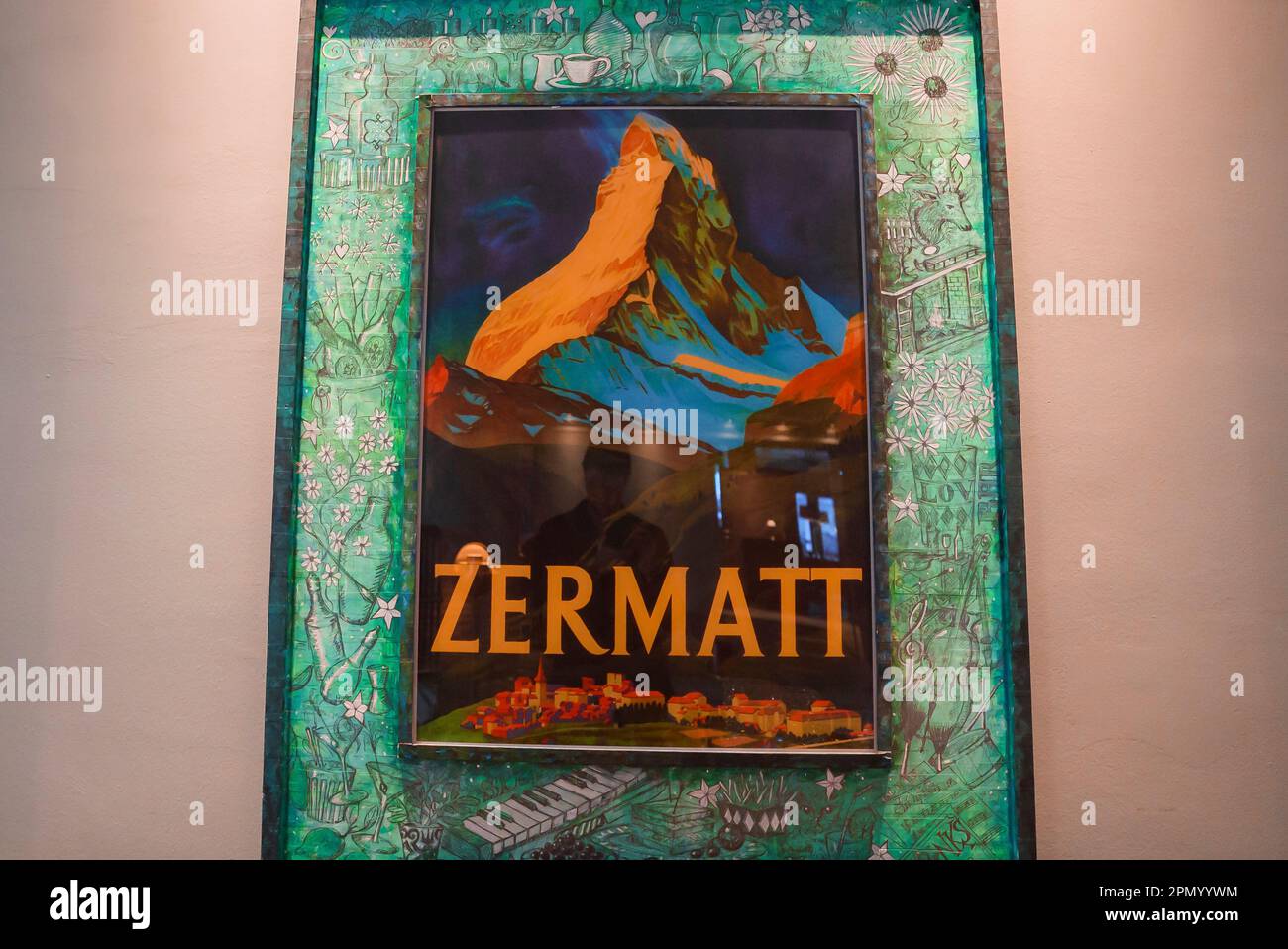 Painting of mountain with Zermatt text mounted on wall in resort Stock ...