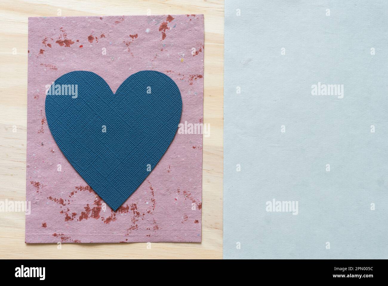 blue paper heart on stained paper and wood near a blank sheet Stock ...