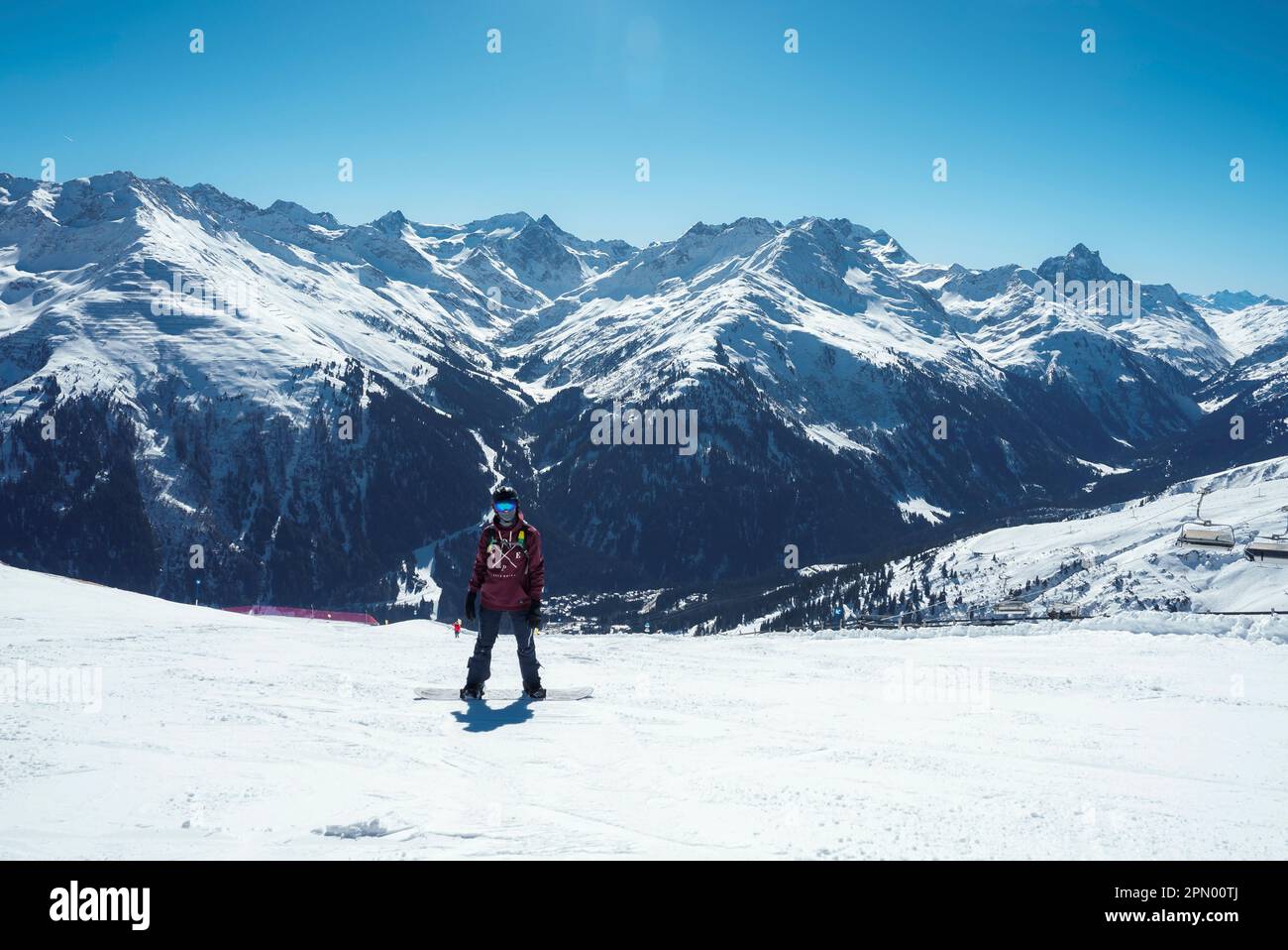 Tourist on peak of snow covered mountain during vacation Stock Photo ...