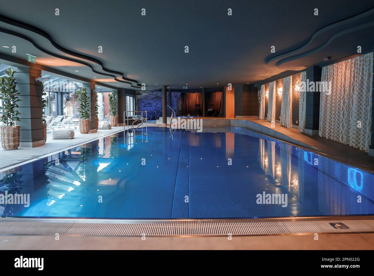 Swimming pool located in center luxury hotel room Stock Photo - Alamy
