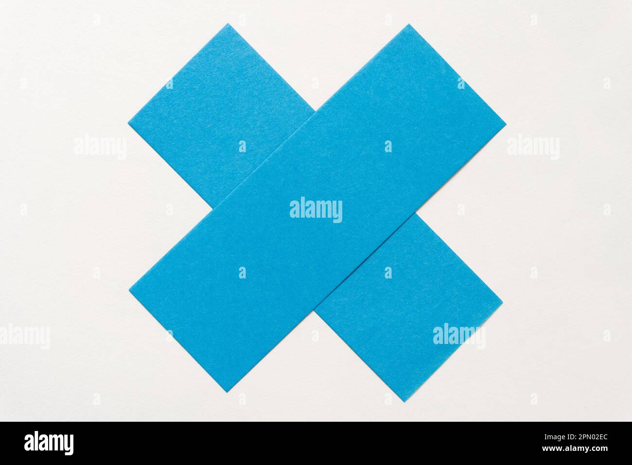 giant blue paper X on blank paper Stock Photo - Alamy