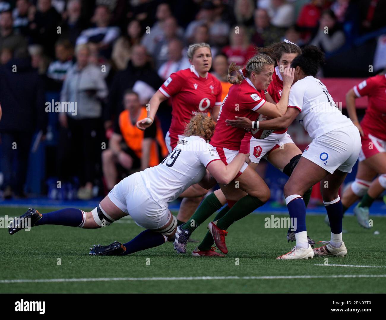 Cardiff,UK, 15 Apr 2023 Delaney Burns (England) (L) tackles Hannah Jones (Wales) (C) during the ...