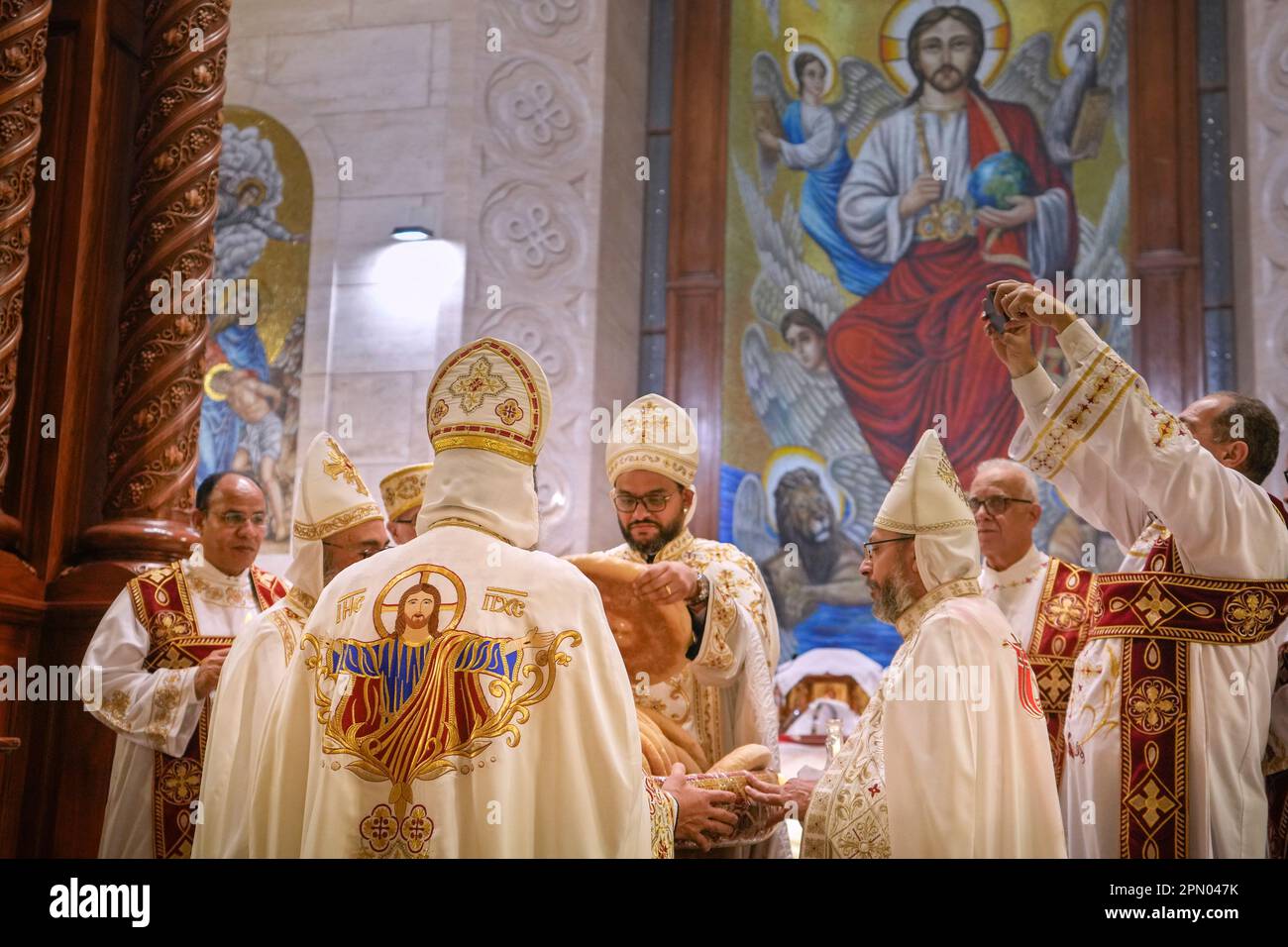 Bishop Antonios Ezzat prepares Communion bread during Mass on the eve ...