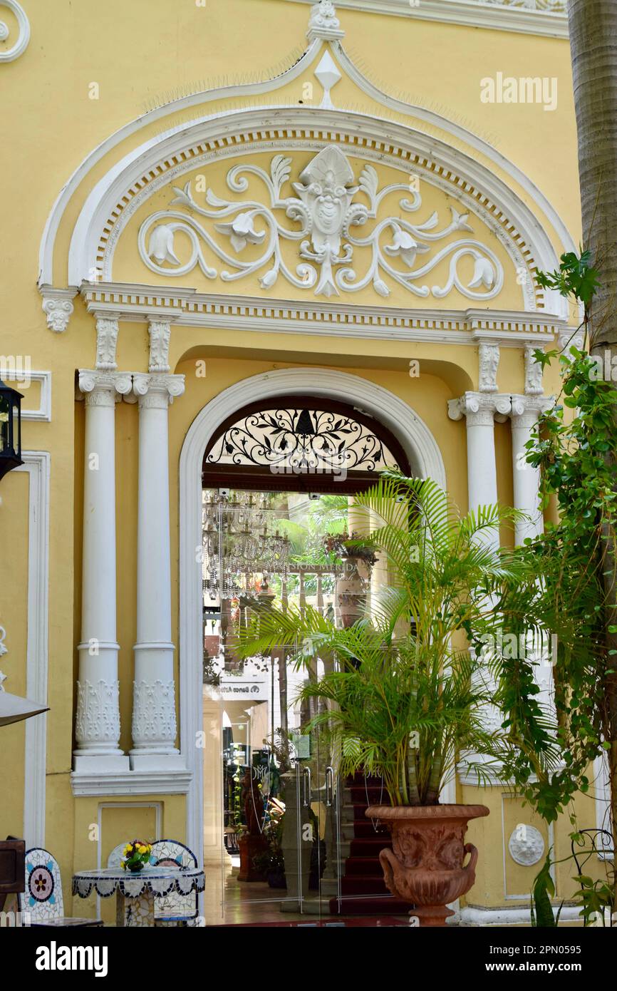 The beautiful, light yellow facade of a hotel facing Parque Hidalgo in ...