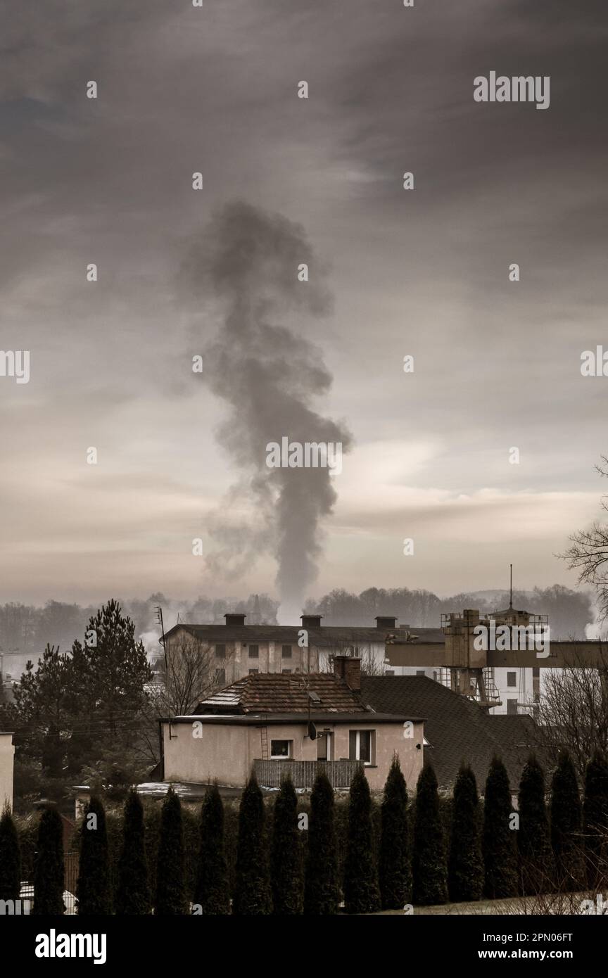 A black plume of smoke is billowing from an urban skyline of buildings ...